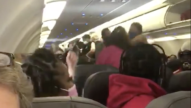 Watch passengers fight on a plane over masks - CGTN