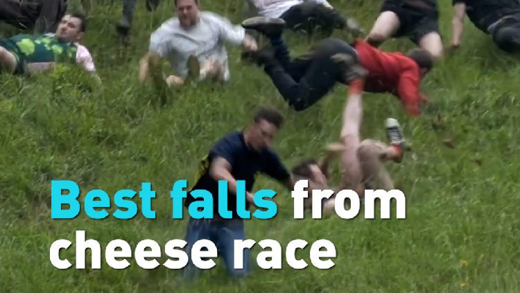 Spectacular slow motion falls down a hill chasing a wheel of cheese - CGTN